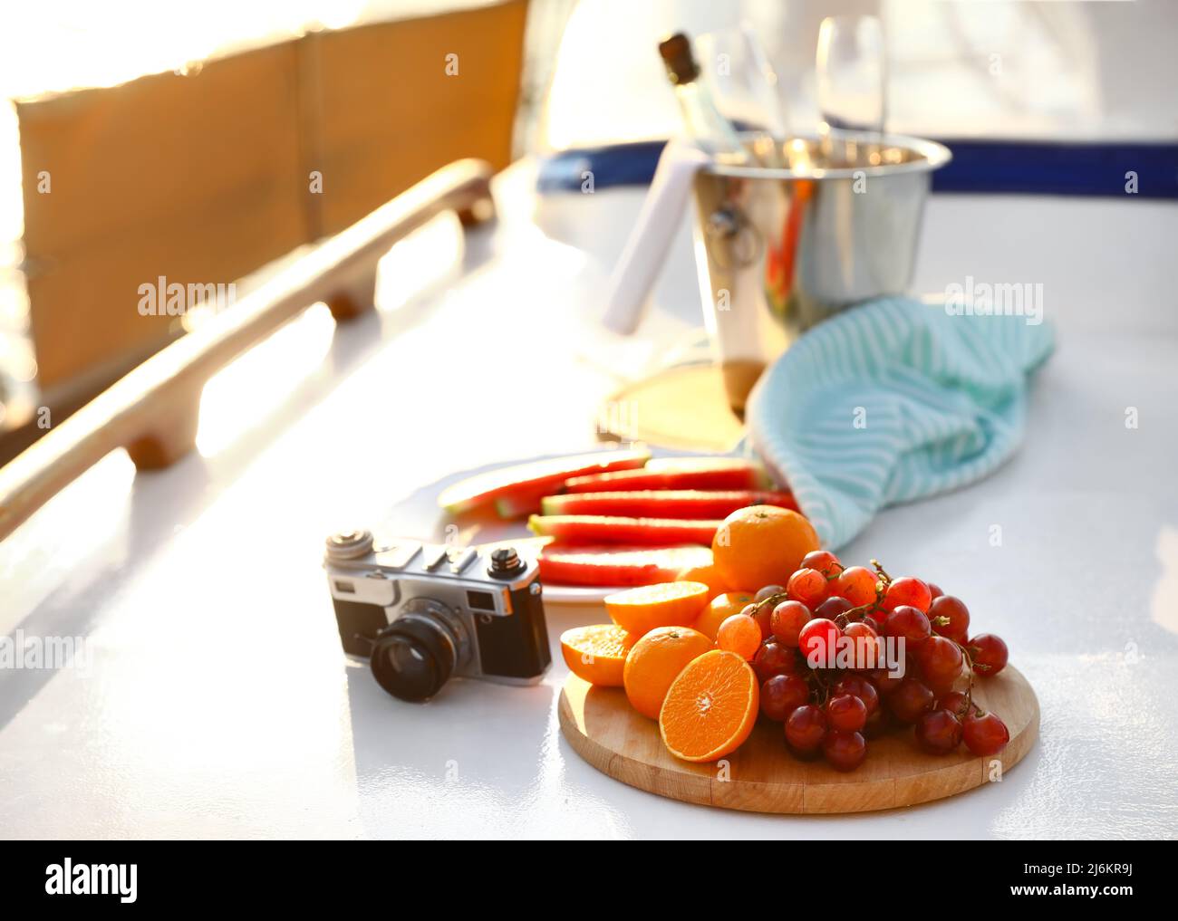 Fresh fruits with photo camera on deck of yacht Stock Photo - Alamy