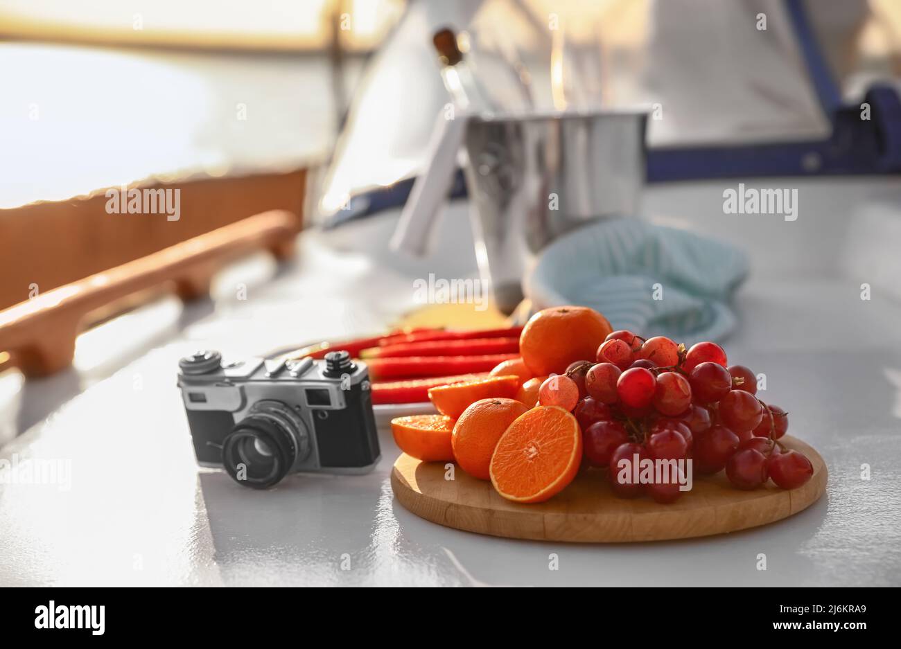 Fresh fruits with photo camera on deck of yacht Stock Photo - Alamy