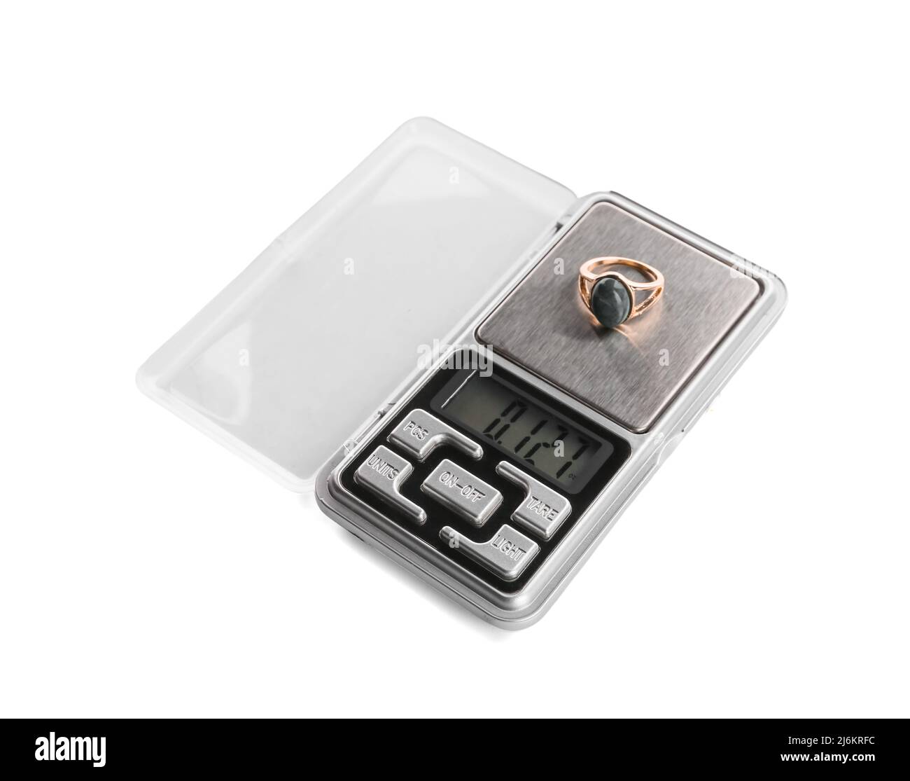 Jewelry scales with ring on white background Stock Photo - Alamy