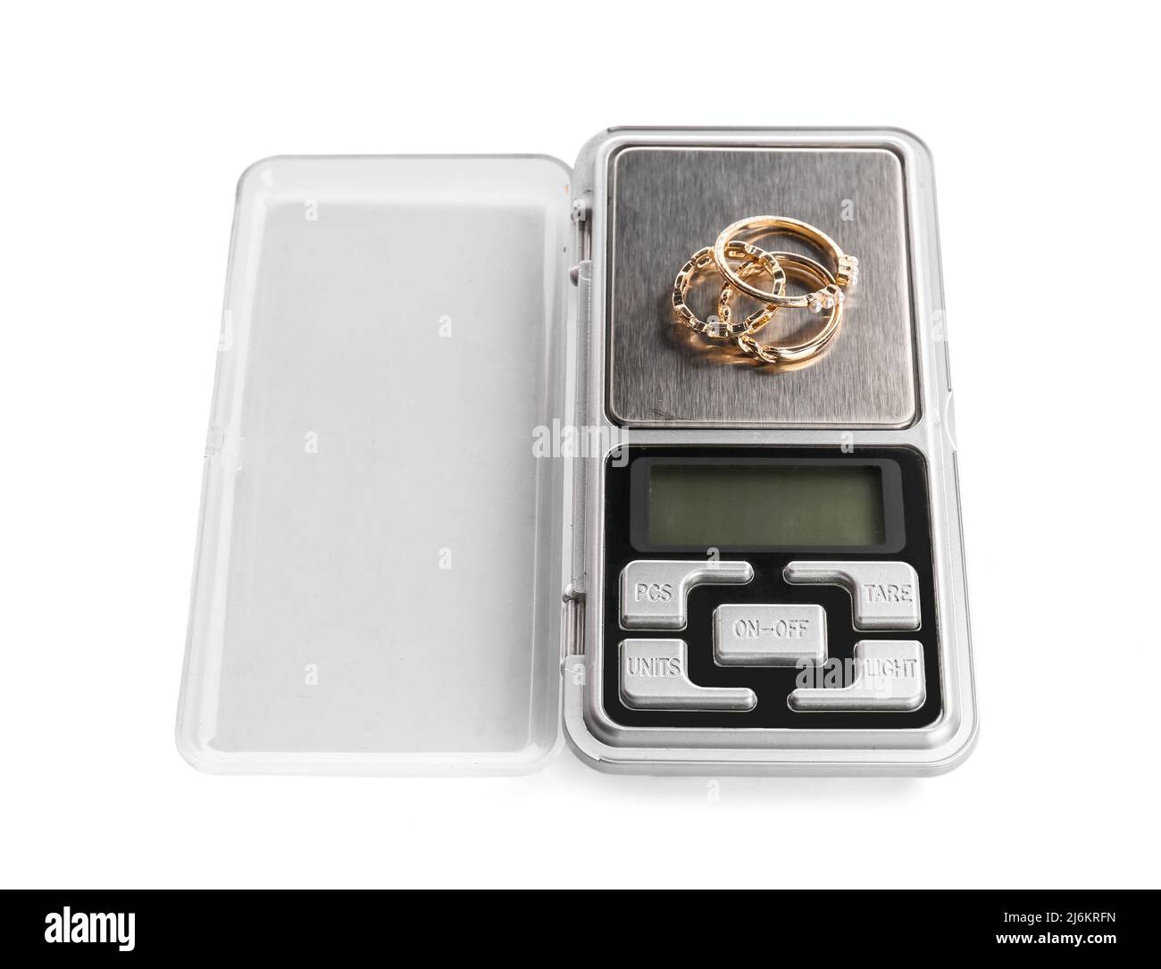 Jewelry scales with rings on white background Stock Photo - Alamy