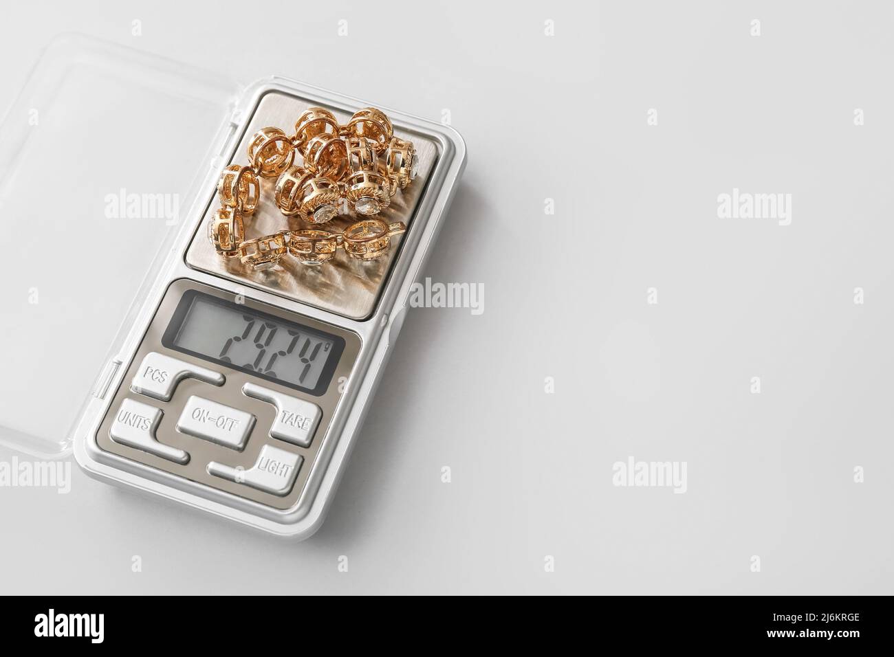 Jewelry scales with chain on white background Stock Photo - Alamy
