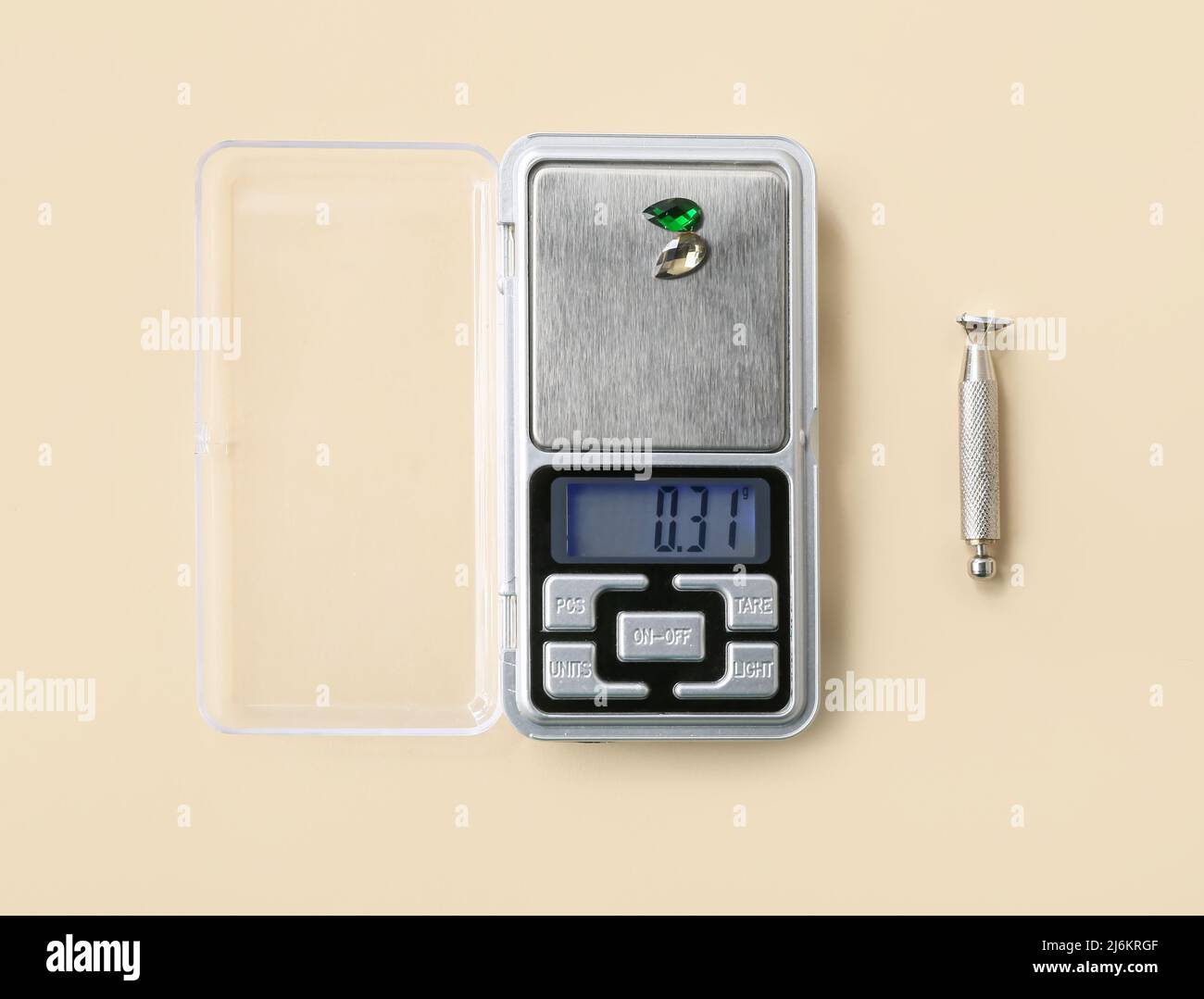 Jewelry scales with gem stones on beige background Stock Photo - Alamy