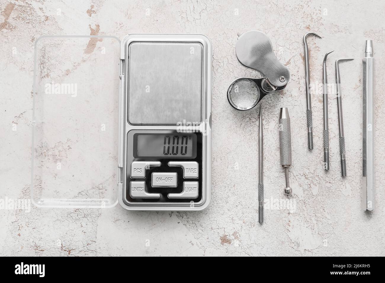 Jewelry scales with different tools on light background Stock Photo - Alamy