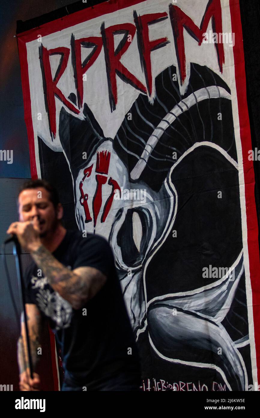 Singer Pierre Marche performs in front of a punk banner. The Punk Rock ...