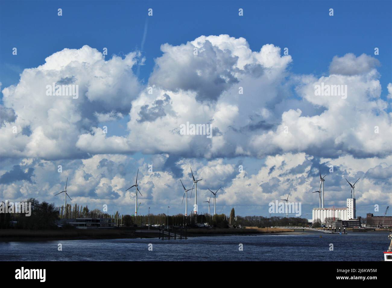 wind turbines against a cloudy sky in Antwerp Stock Photo - Alamy