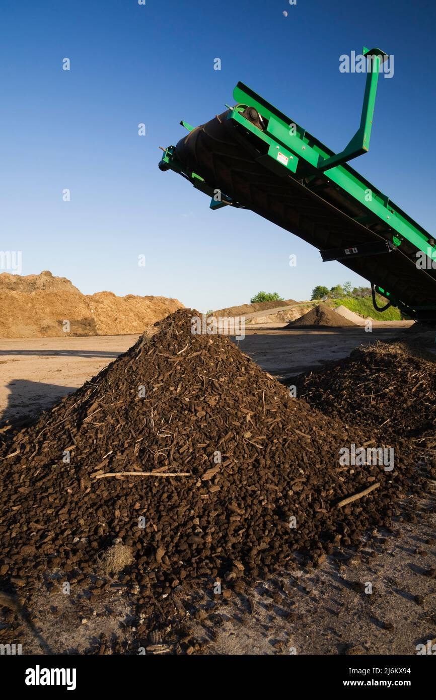 Mound of tree bark shavings and topsoil residues after having passed ...