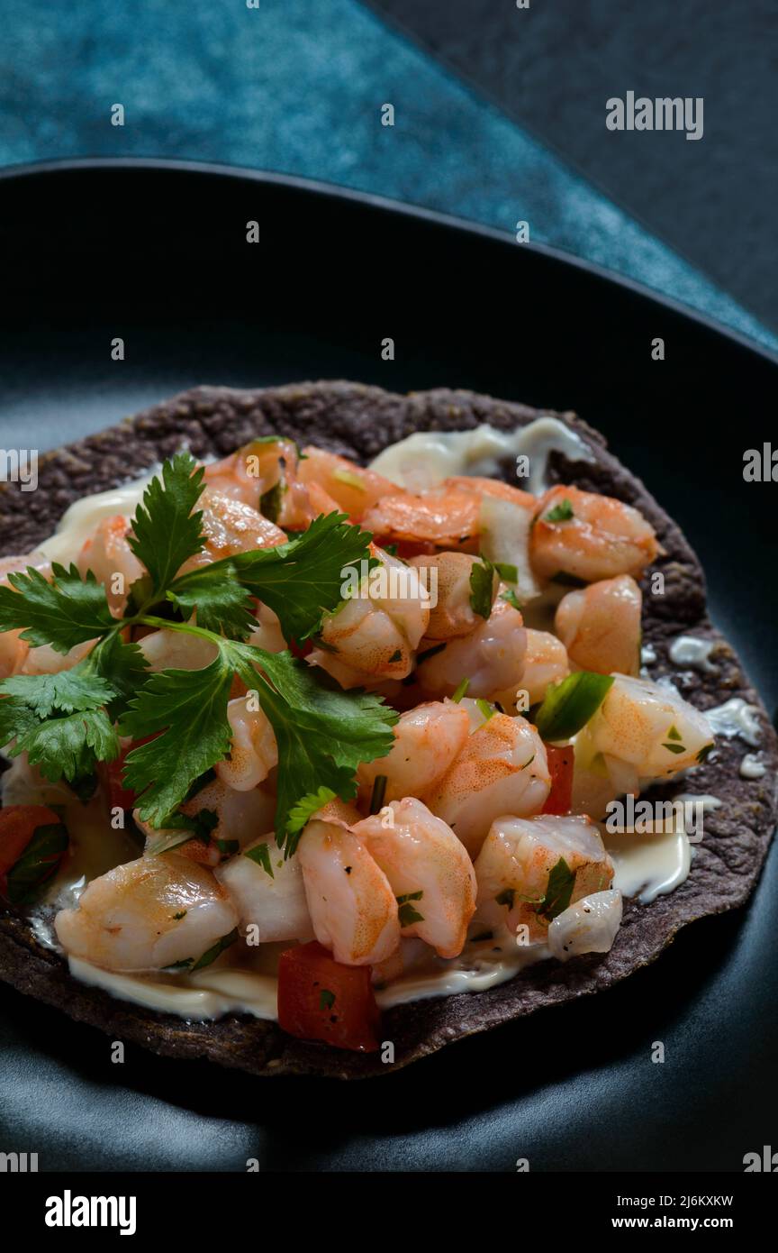 Red shrimp ceviche and blue corn tostadas Stock Photo - Alamy