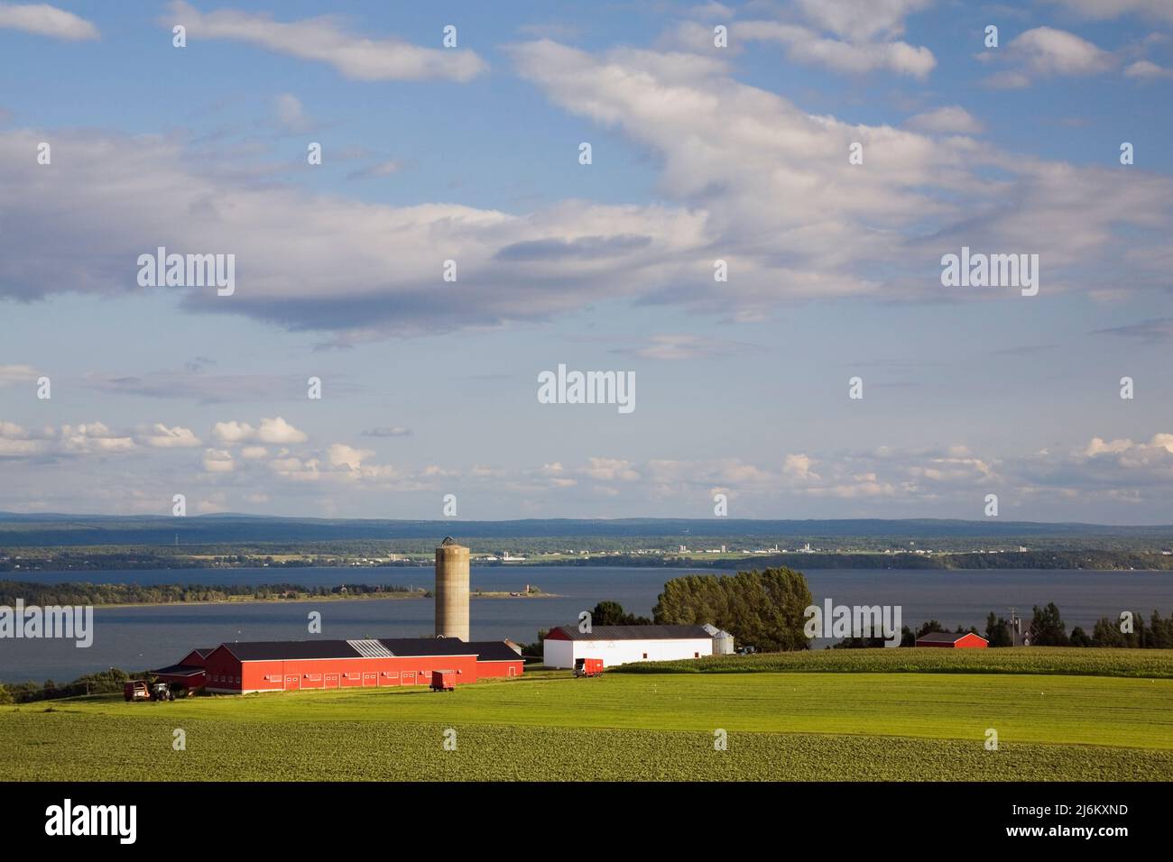 Farm and crop field with view of the Saint-Lawrence river in summer ...