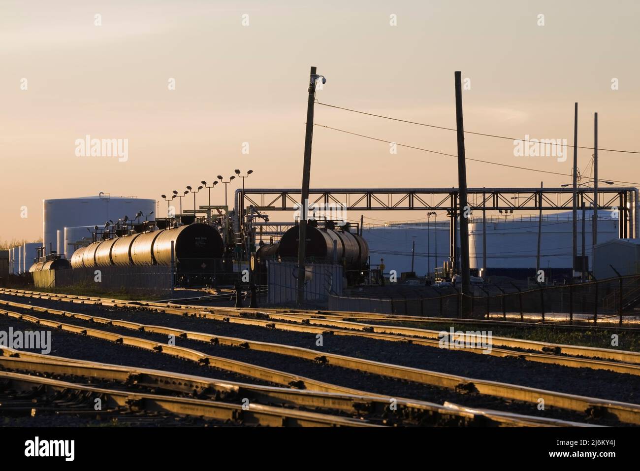 Oil storage tanks and parked black oil tanker rail cars at an oil and ...
