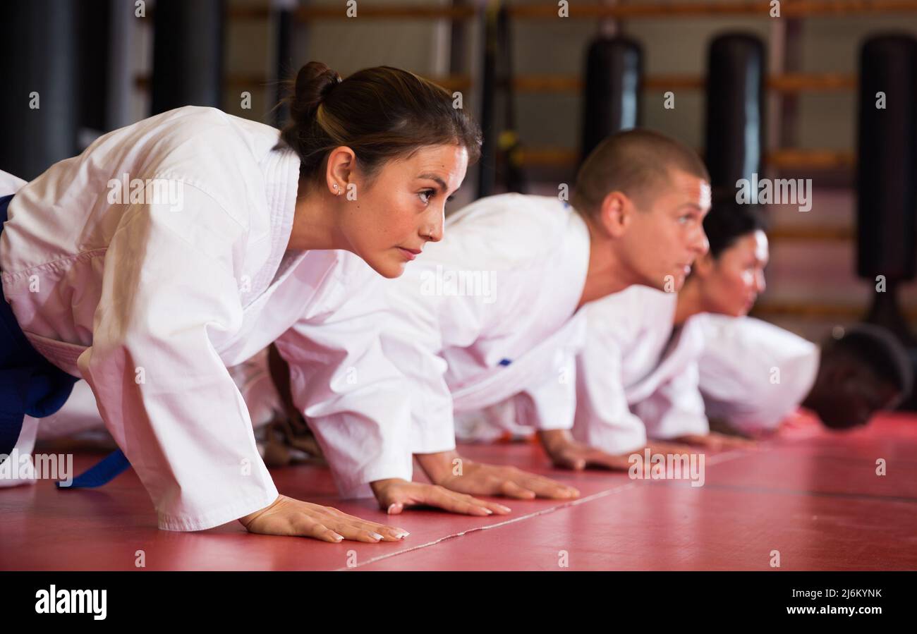 Training Group Of Athletes Before Karate Training Push ups And Muscle