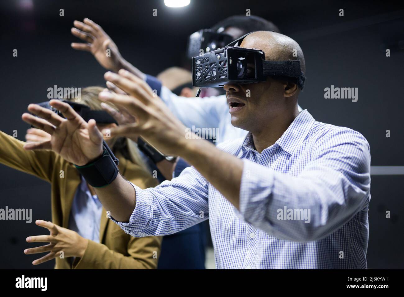 Group of friends are wearing virtual reality goggles in quest room ...