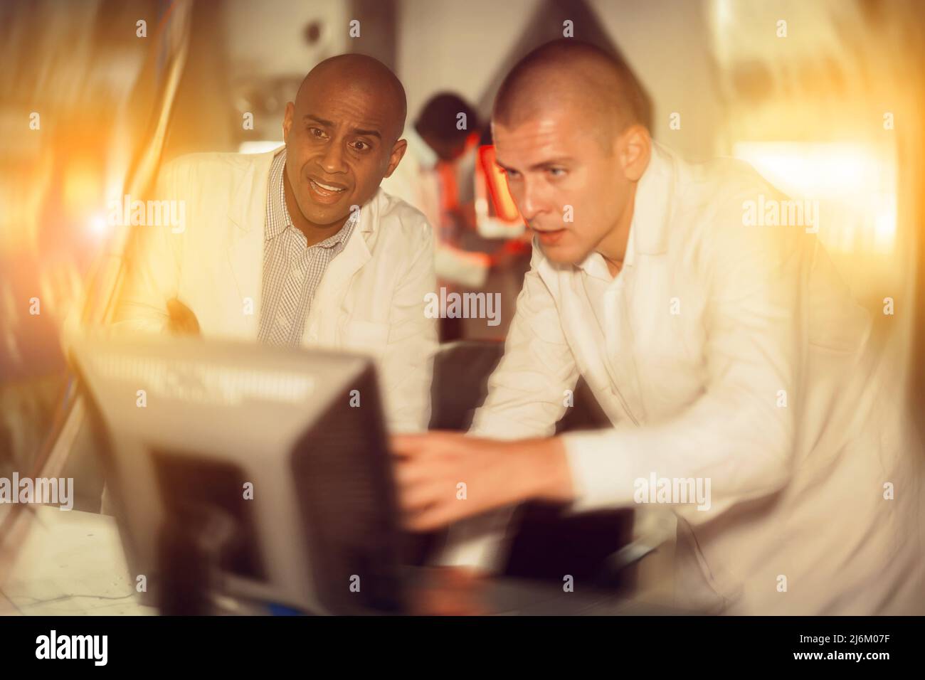 Two men solving puzzle in escape room Stock Photo - Alamy