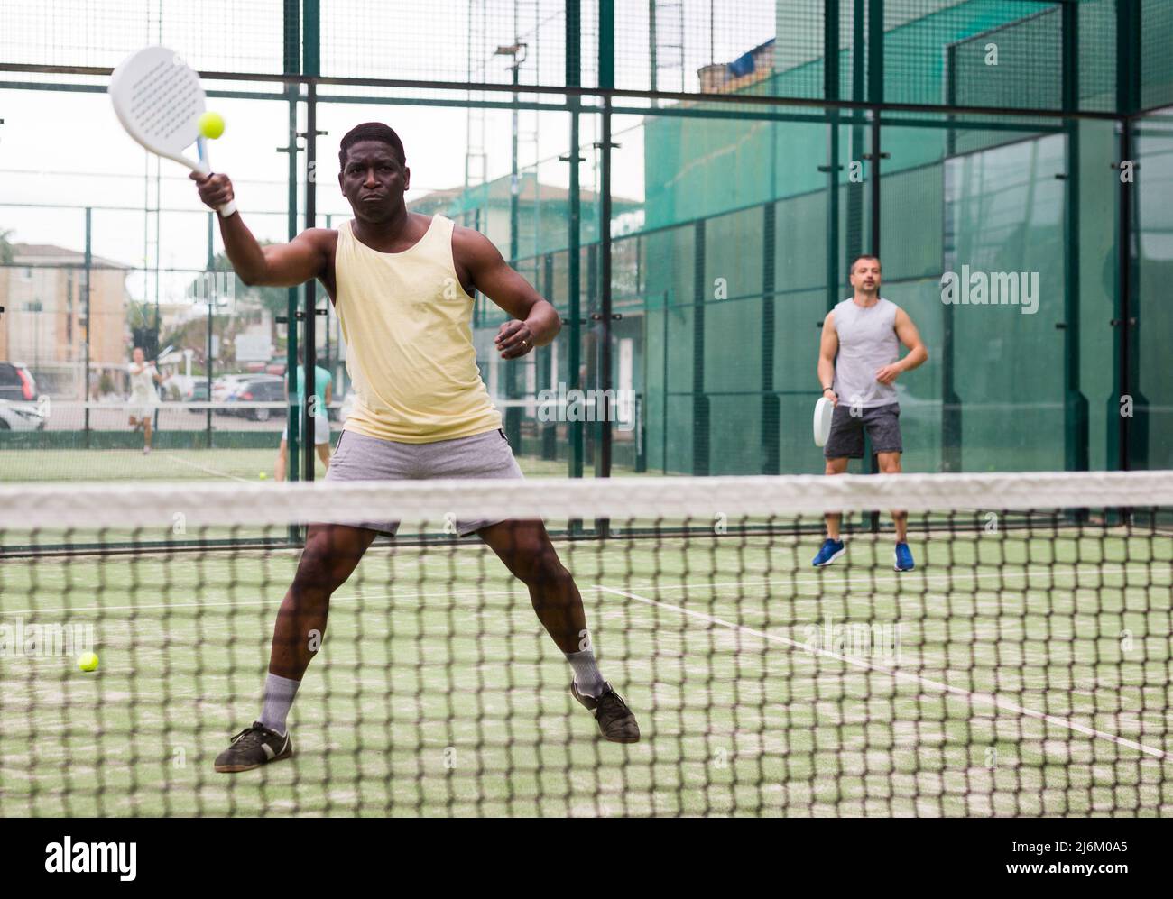 African american man and his partner playing paddle tennis on padel ...