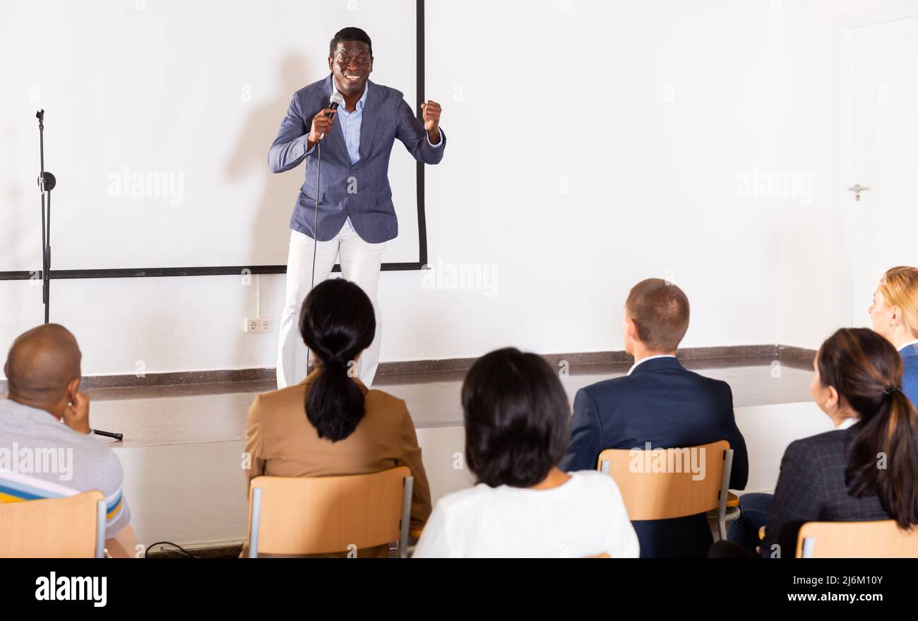 Young emotional male coach giving motivational speech Stock Photo - Alamy