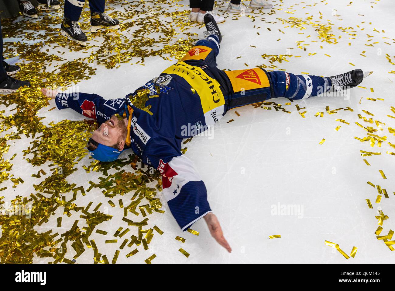 Carl Klingberg #48 (EV Zug) makes the confetti angel during the ...