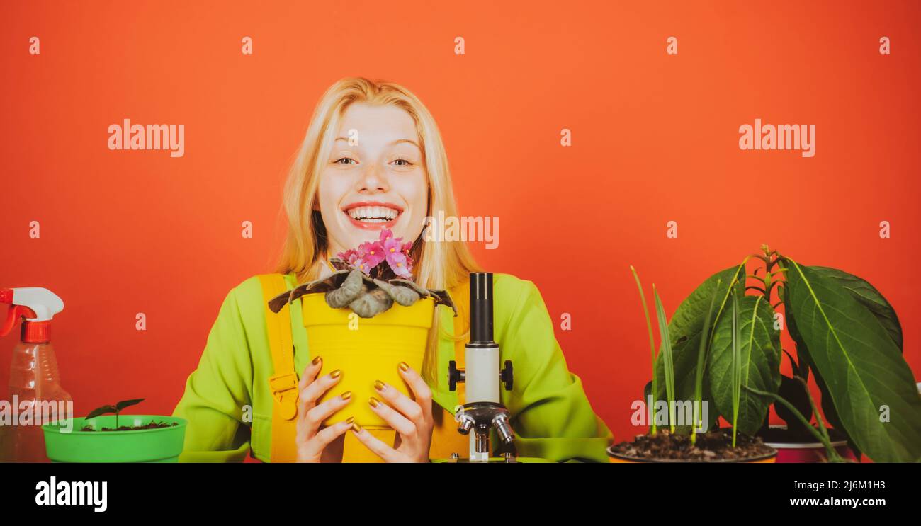 Happy florist posing with flower to camera. Portrait of joyful lady in ...