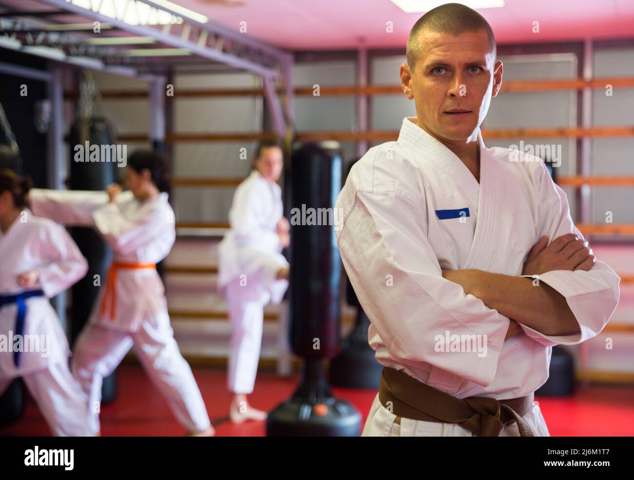 Karate trainer standing in gym Stock Photo - Alamy