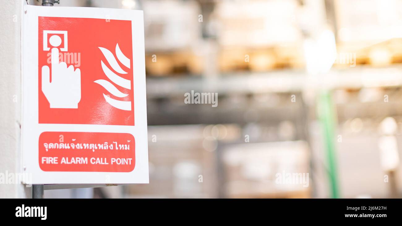 Red fire alarm sign on the white wall for safety first and sign to ...