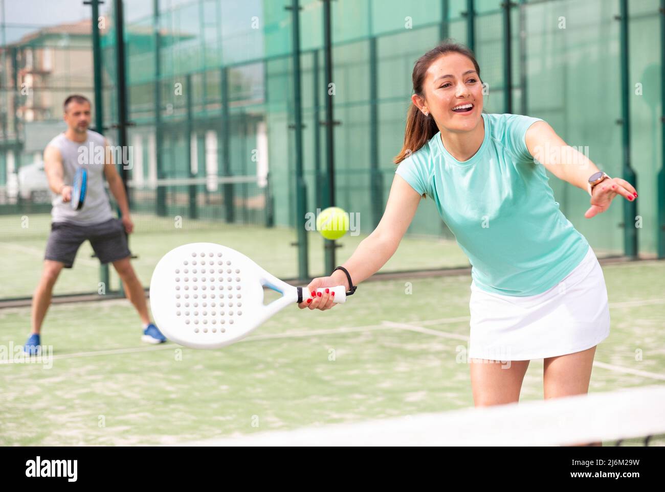 Young emotional woman playing paddle tennis outdoors Stock Photo - Alamy
