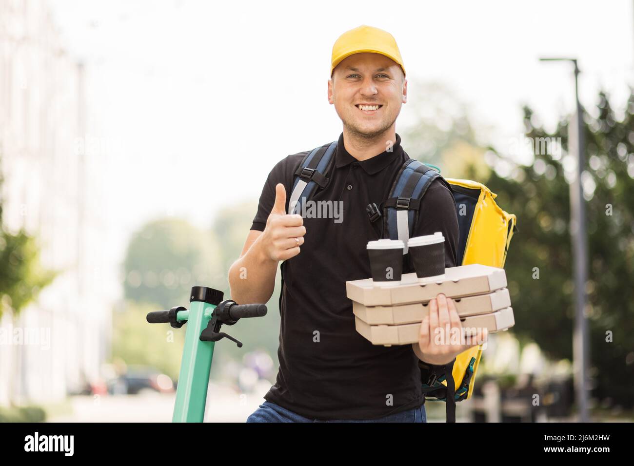 Young courier, pizza and coffee delivery man with thermal backpack and ...