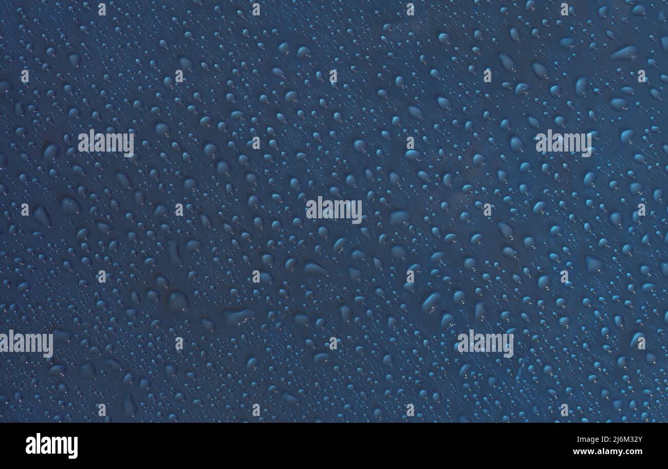 Droplet texture. Wet drop water on glass blue background Stock Photo ...