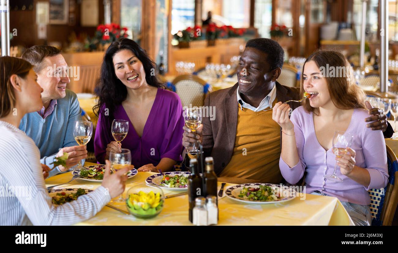 Happy adult people having fun in restaurant during dinner Stock Photo ...