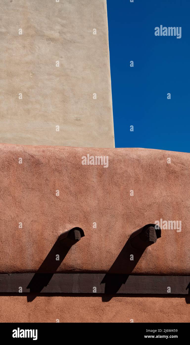 large wooden beams protruding from concrete exterior wall of adobe home ...