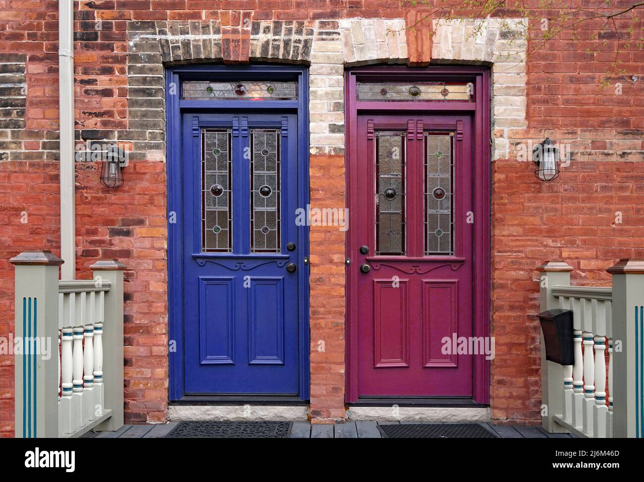 Colorful front doors of Victorian semi-detached houses with shared ...