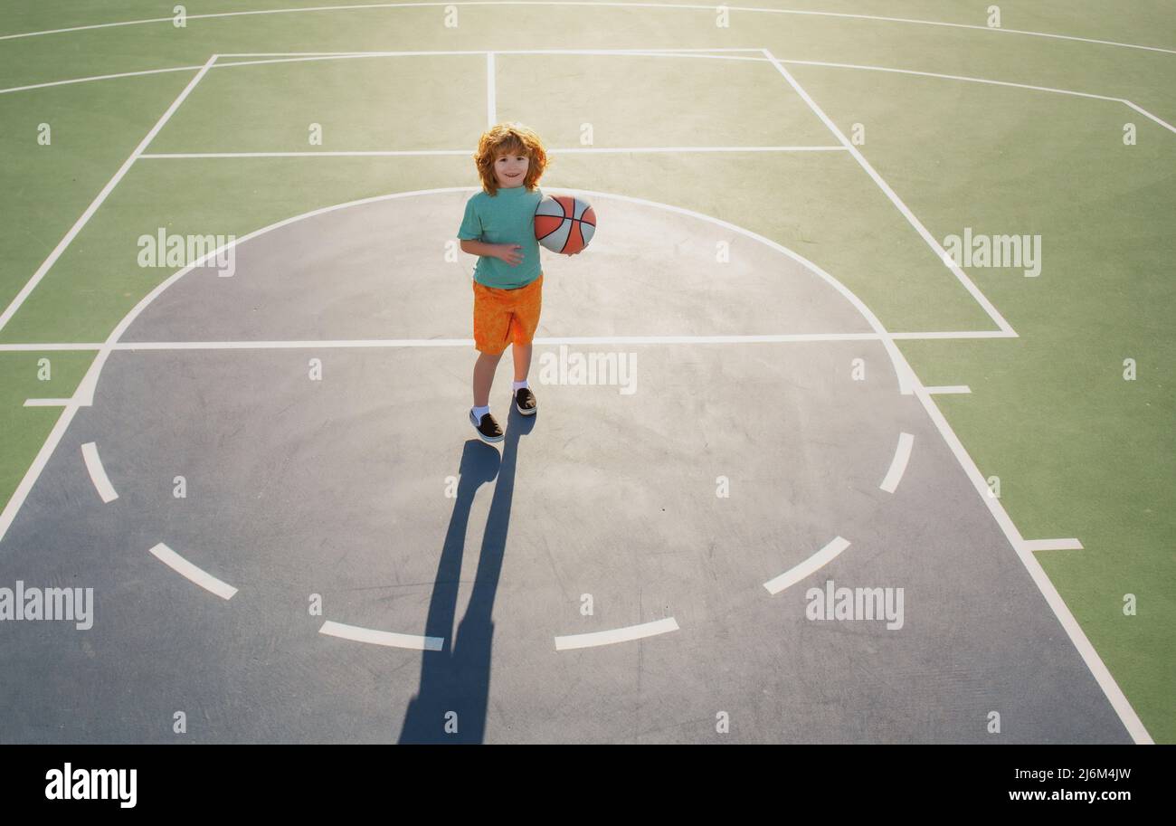 Basketball kids game. Cute little child boy holding a basket ball ...