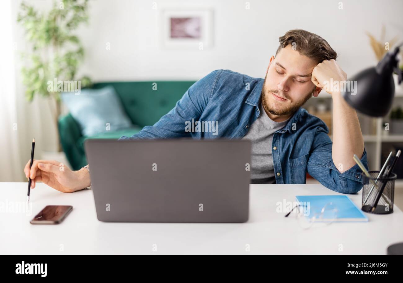 Sleepy man working on computer hi-res stock photography and images - Alamy