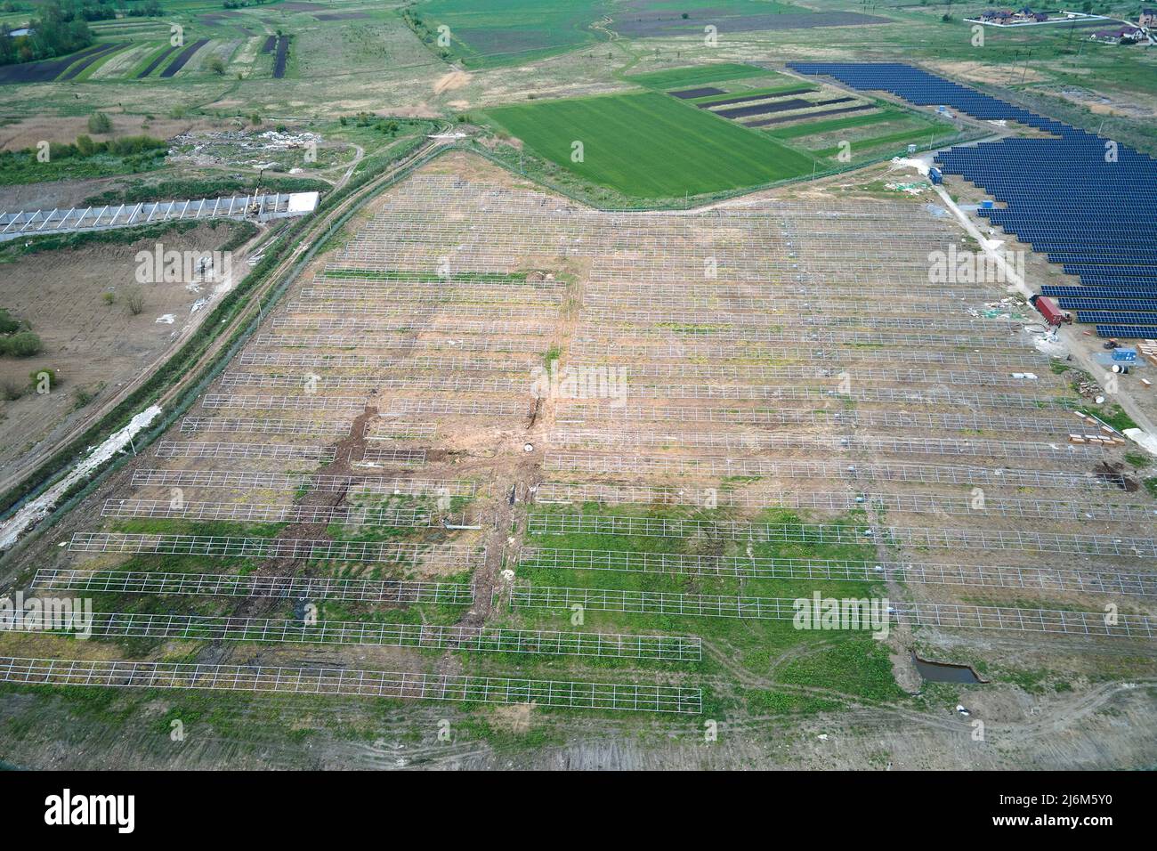 Aerial view of big electric power plant under construction with many ...