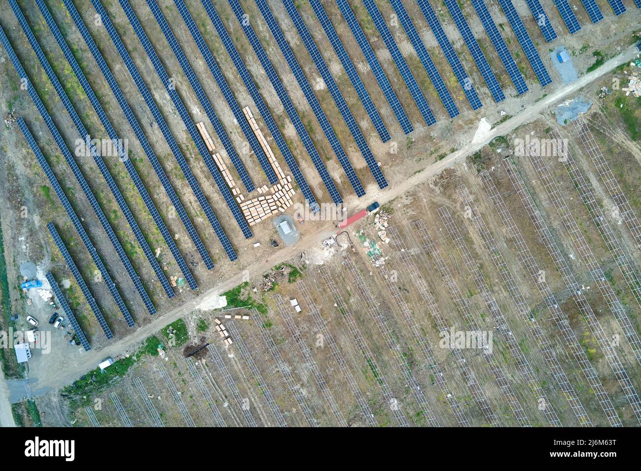 Aerial view of electrical power plant under construction with truck ...