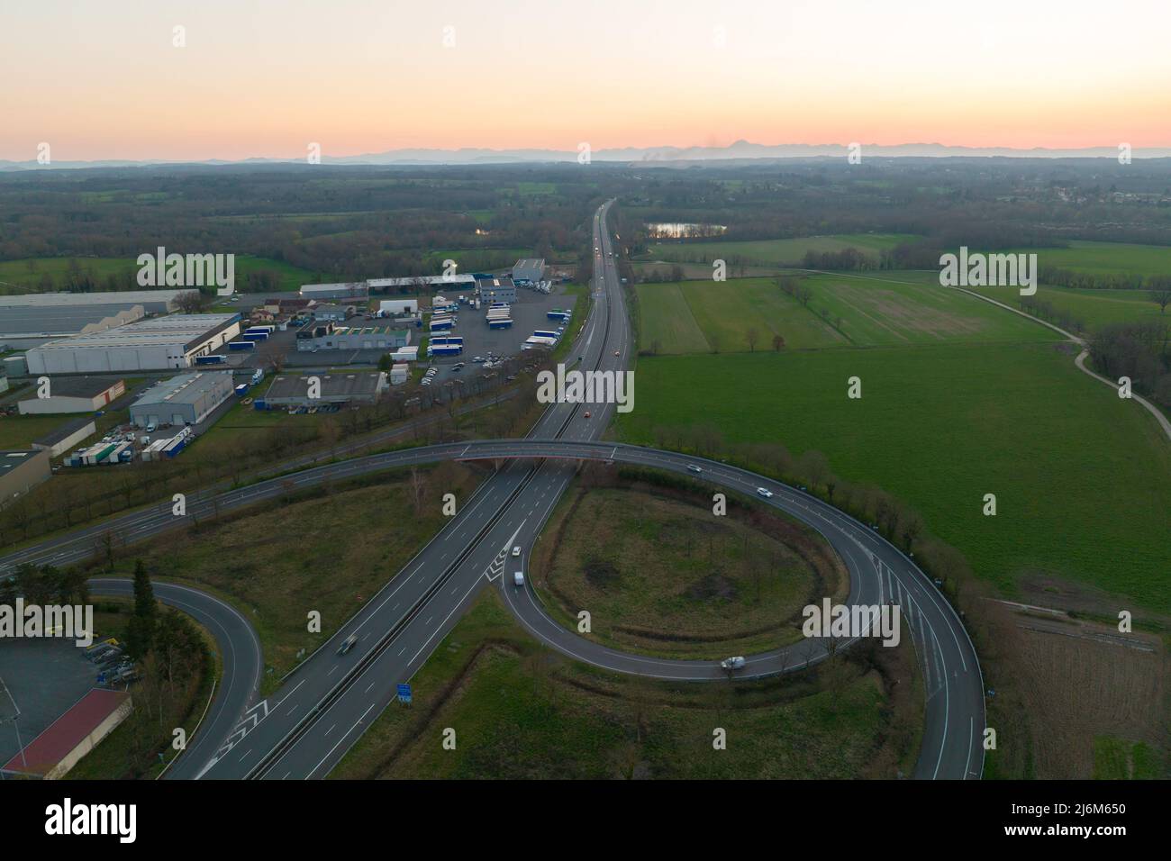 Aerial view of highway road intersection with fast moving heavy traffic ...