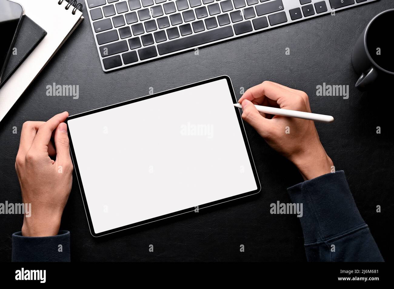 A man using stylus pen, drawing on digital tablet white screen mockup ...