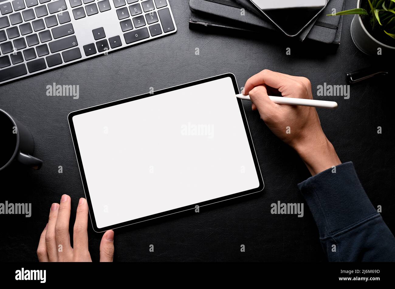 Top view, A man working on his digital tablet at modern black table ...