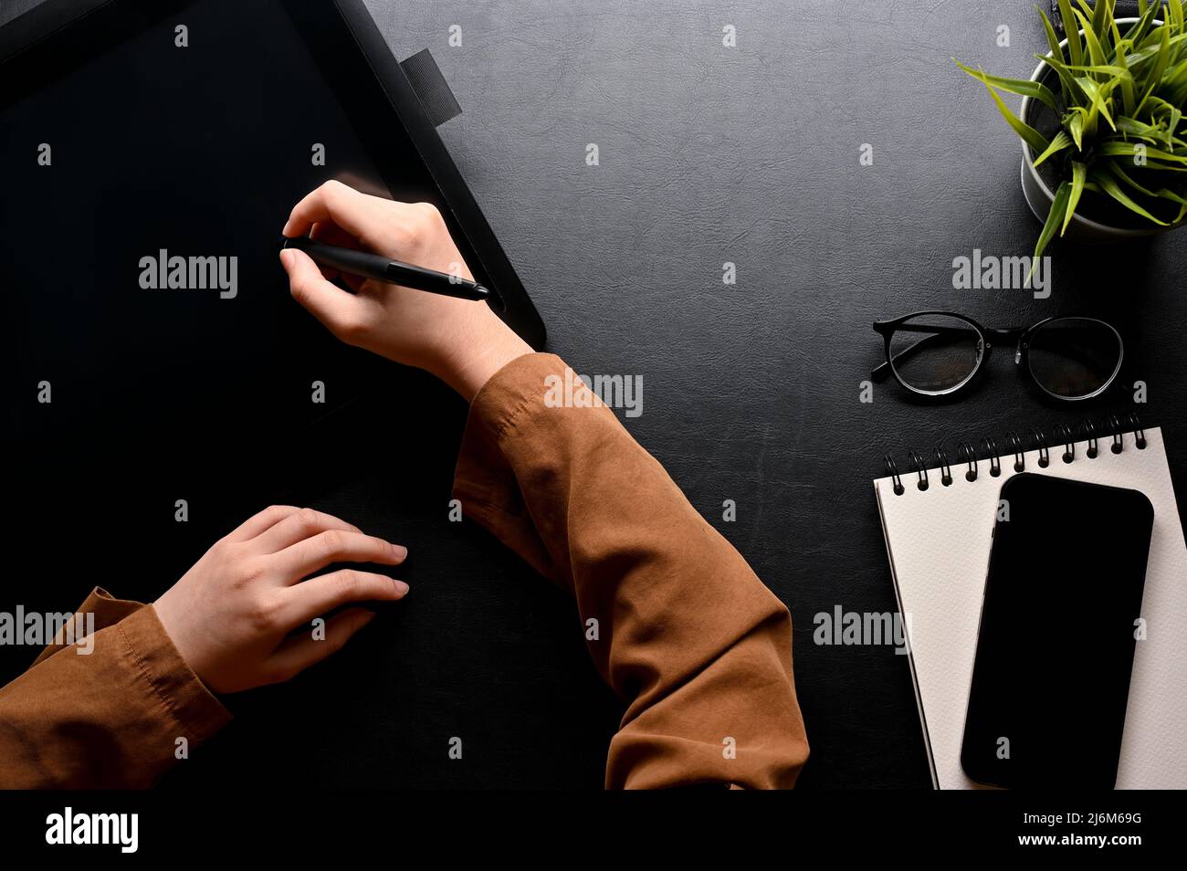 Top view, Female graphic designer working at her modern black office ...