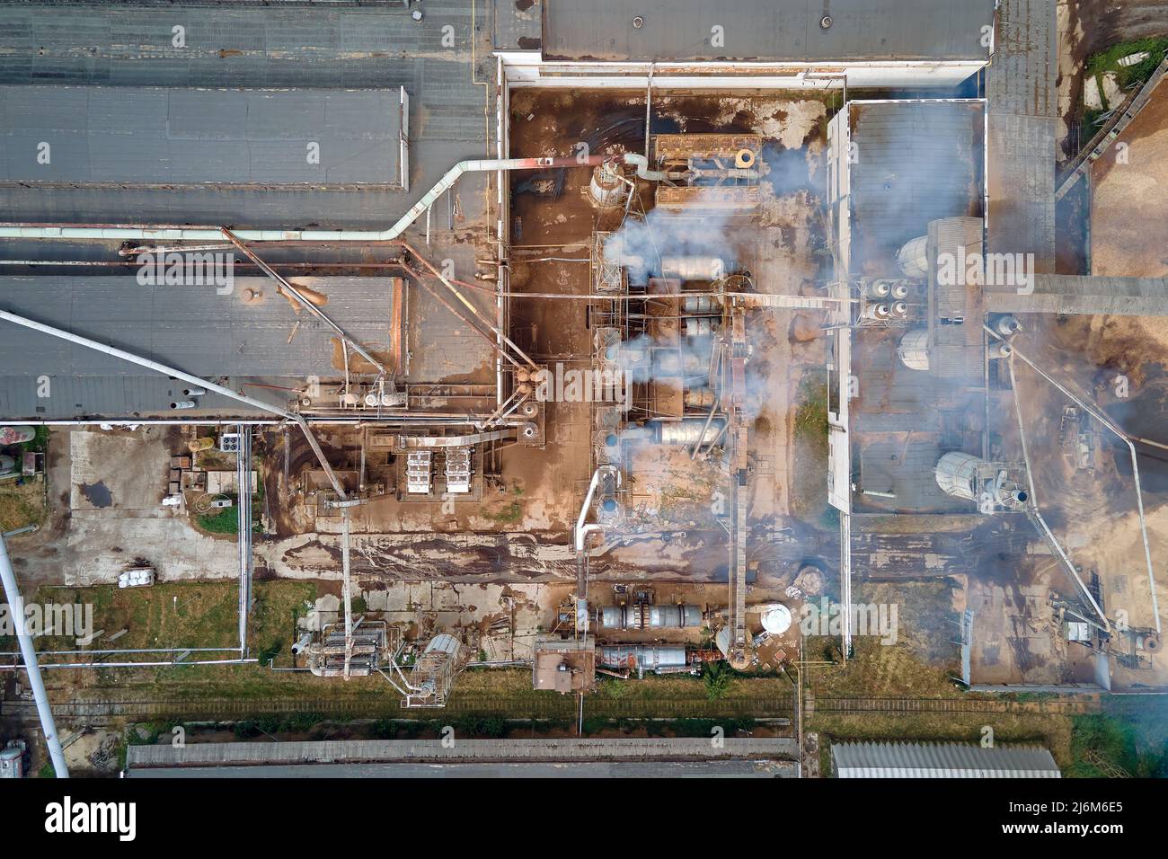 Aerial view of wood processing factory with smoke from production ...