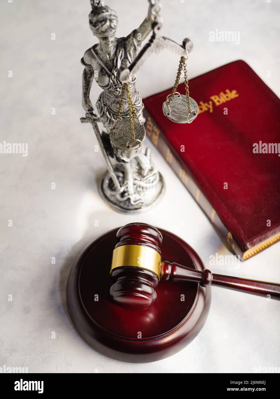 Wooden gavel of the judge, bronze figurine of the goddess of justice ...