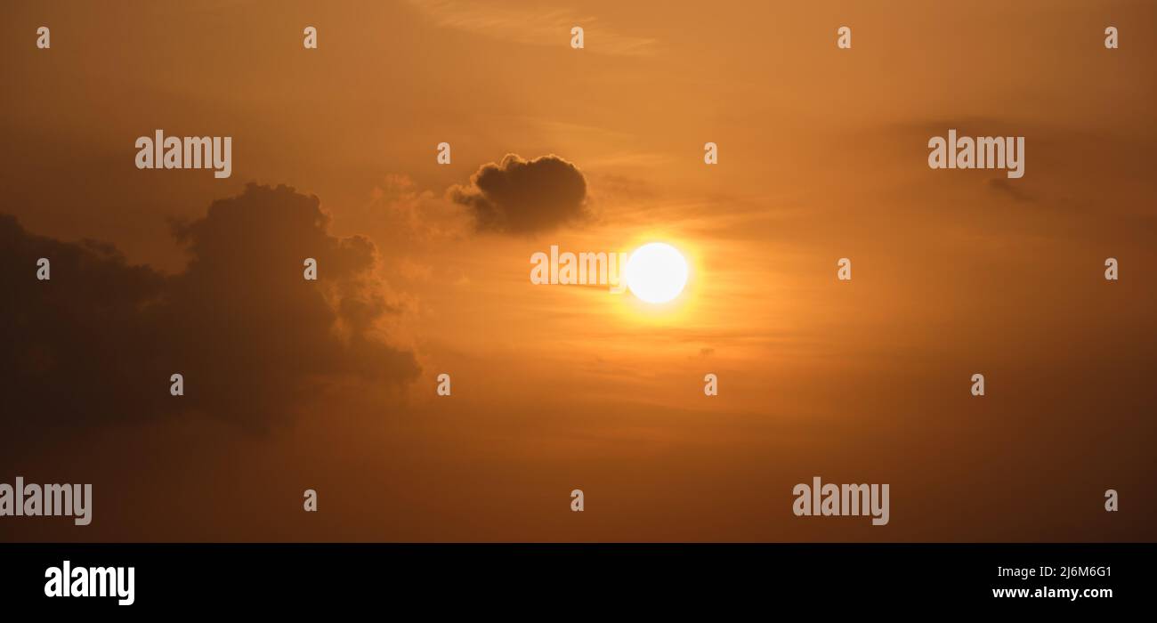 Bright colorful sunset sky with rays of setting sun and vivid dark ...