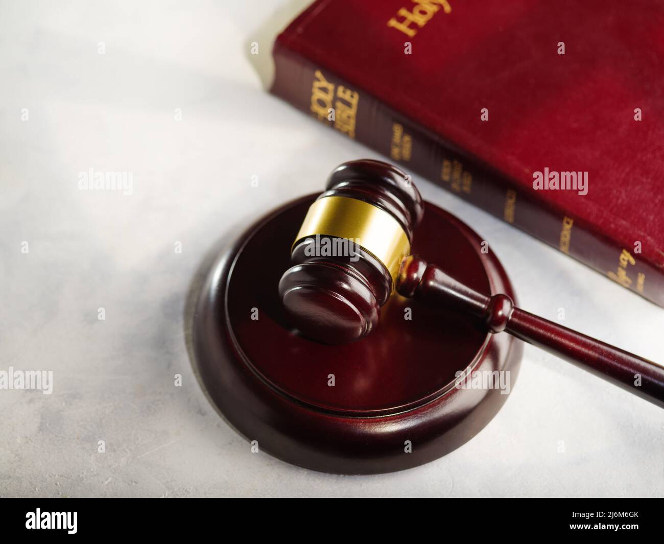 The gavel of the judge and the Holy Bible on a white background. Close ...