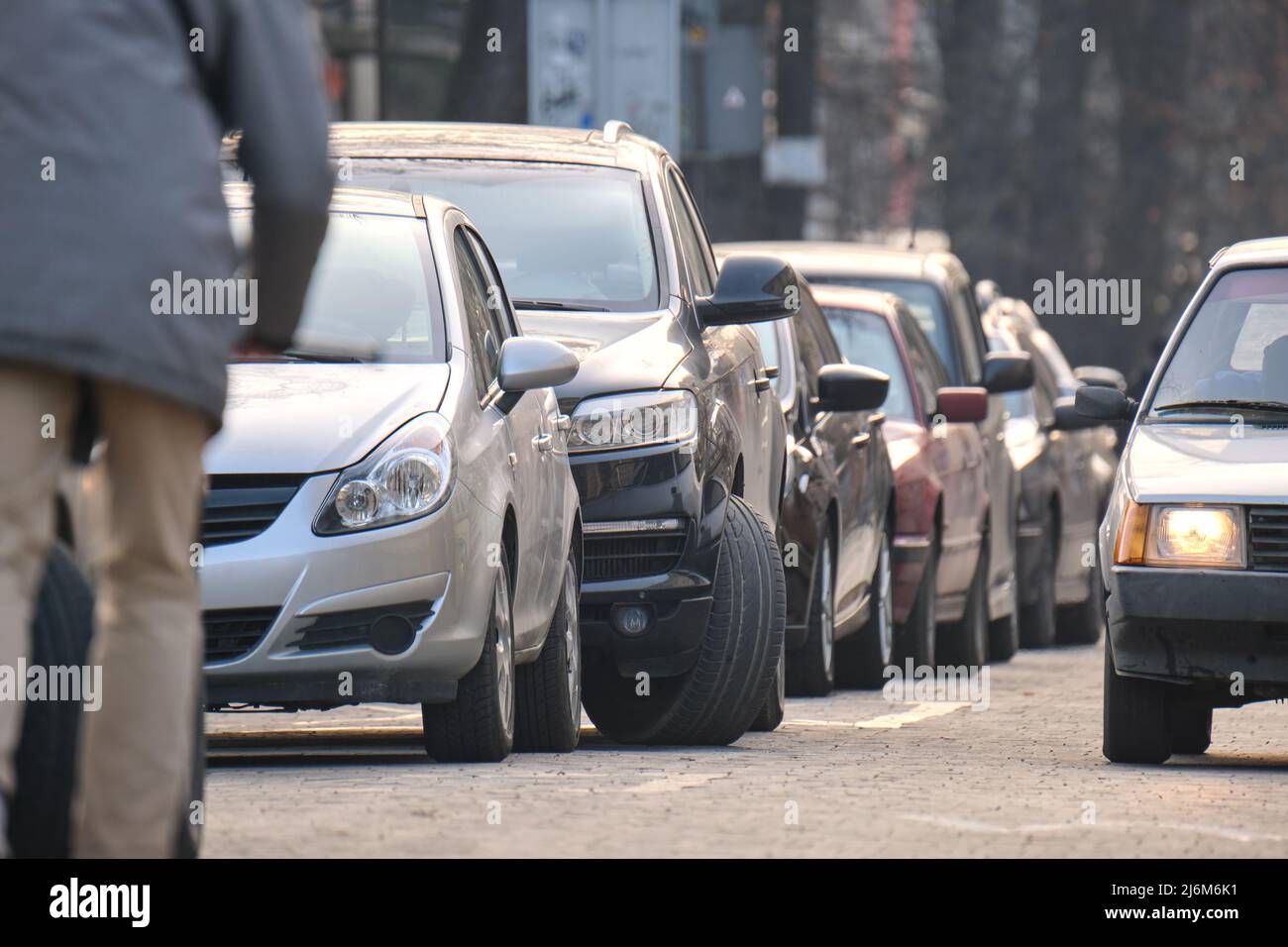 City traffic with cars parked in line on street side Stock Photo - Alamy