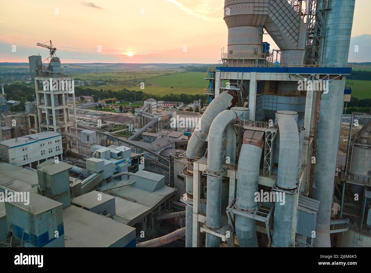 Cement plant with high factory structure and tower cranes at industrial ...