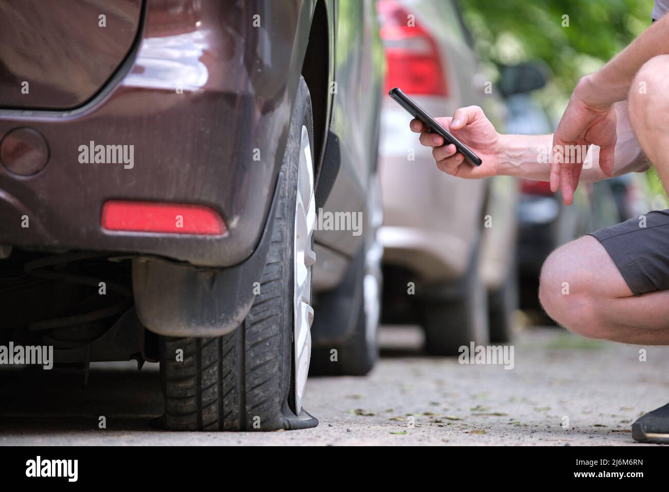 Driver calling road service for assistance having vehicle trouble with ...