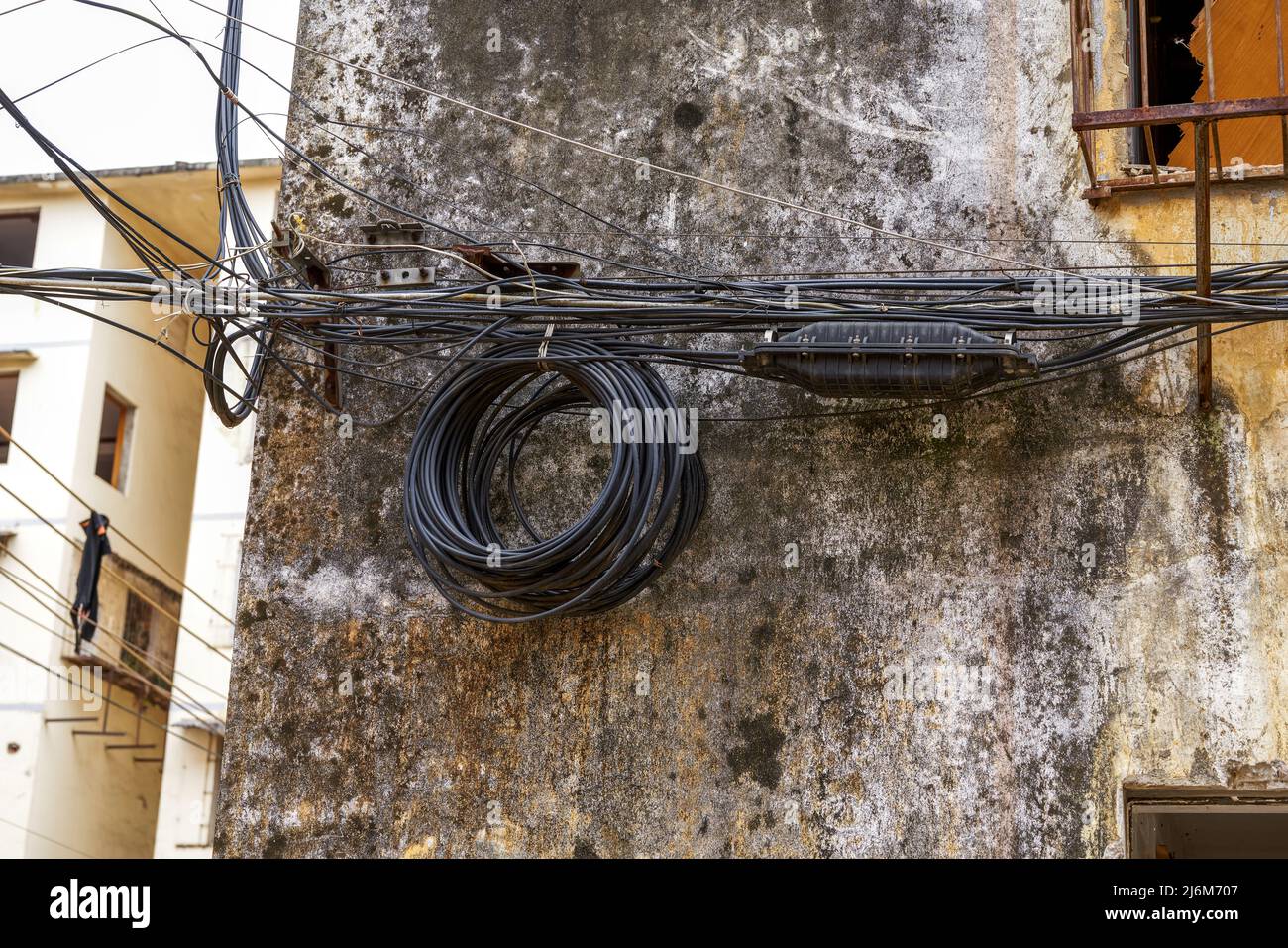 Close-up of a coil of outdoor electrical wiring in an old residential ...