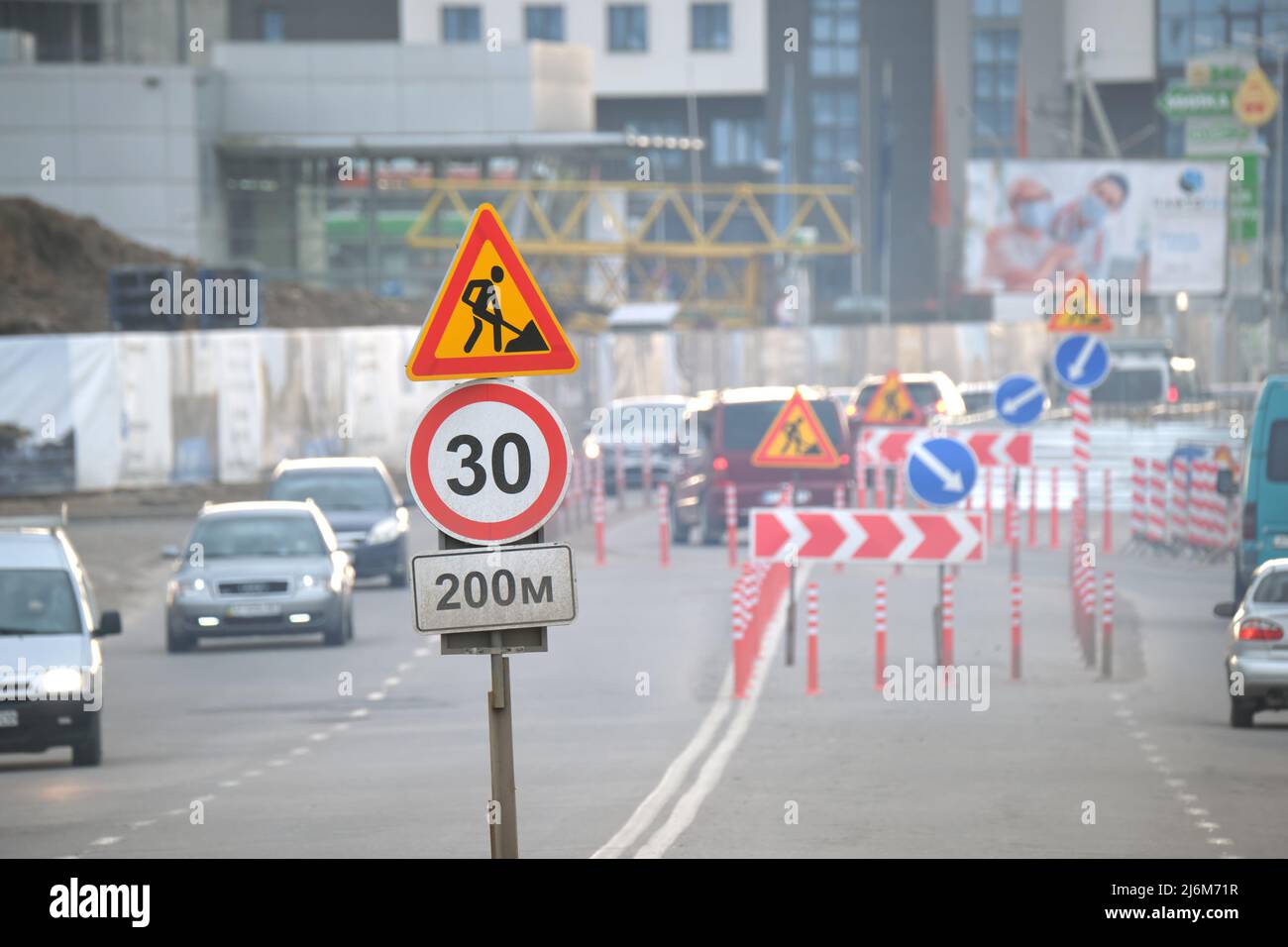 Roadworks warning traffic signs of construction work on city street and ...