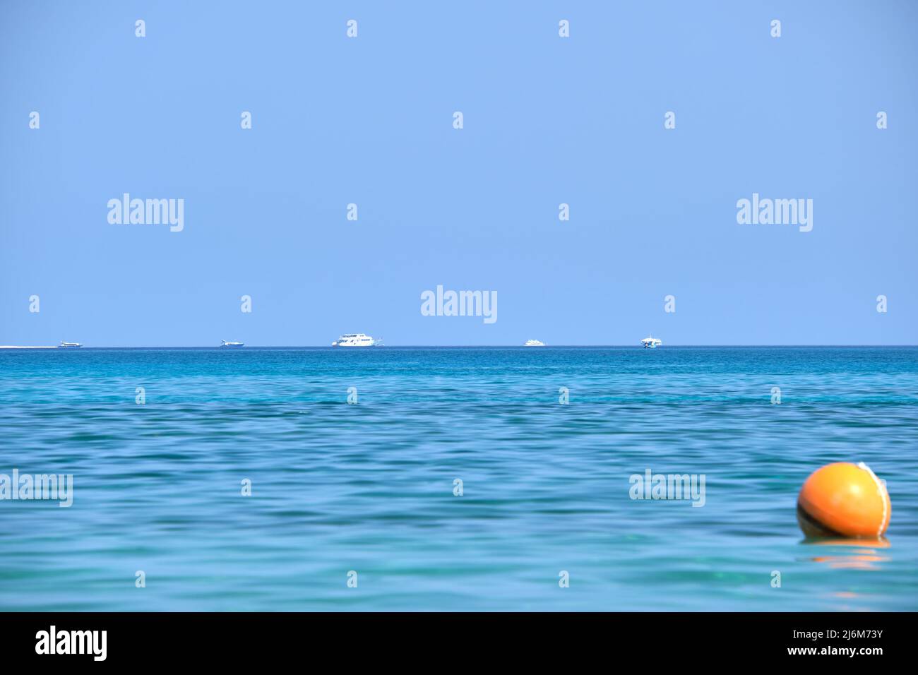 Seascape with ripple surface of blue sea water with distant ships ...