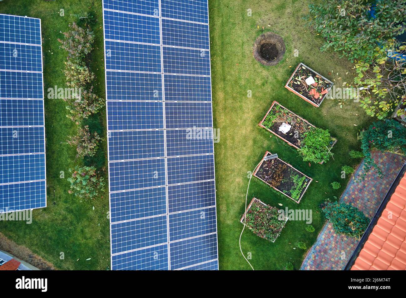 Solar photovoltaic panels mounted on stand-alone frame on backyard ...