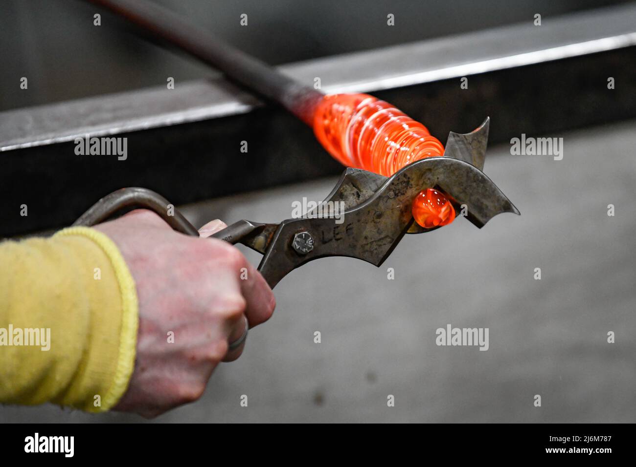 Molten glass being worked into an ornament at melting point Glass ...