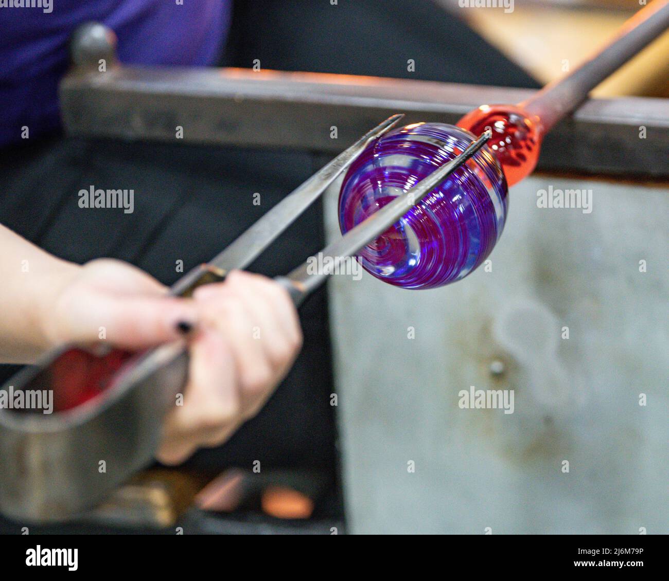 Molten glass being worked into an ornament at melting point Glass ...