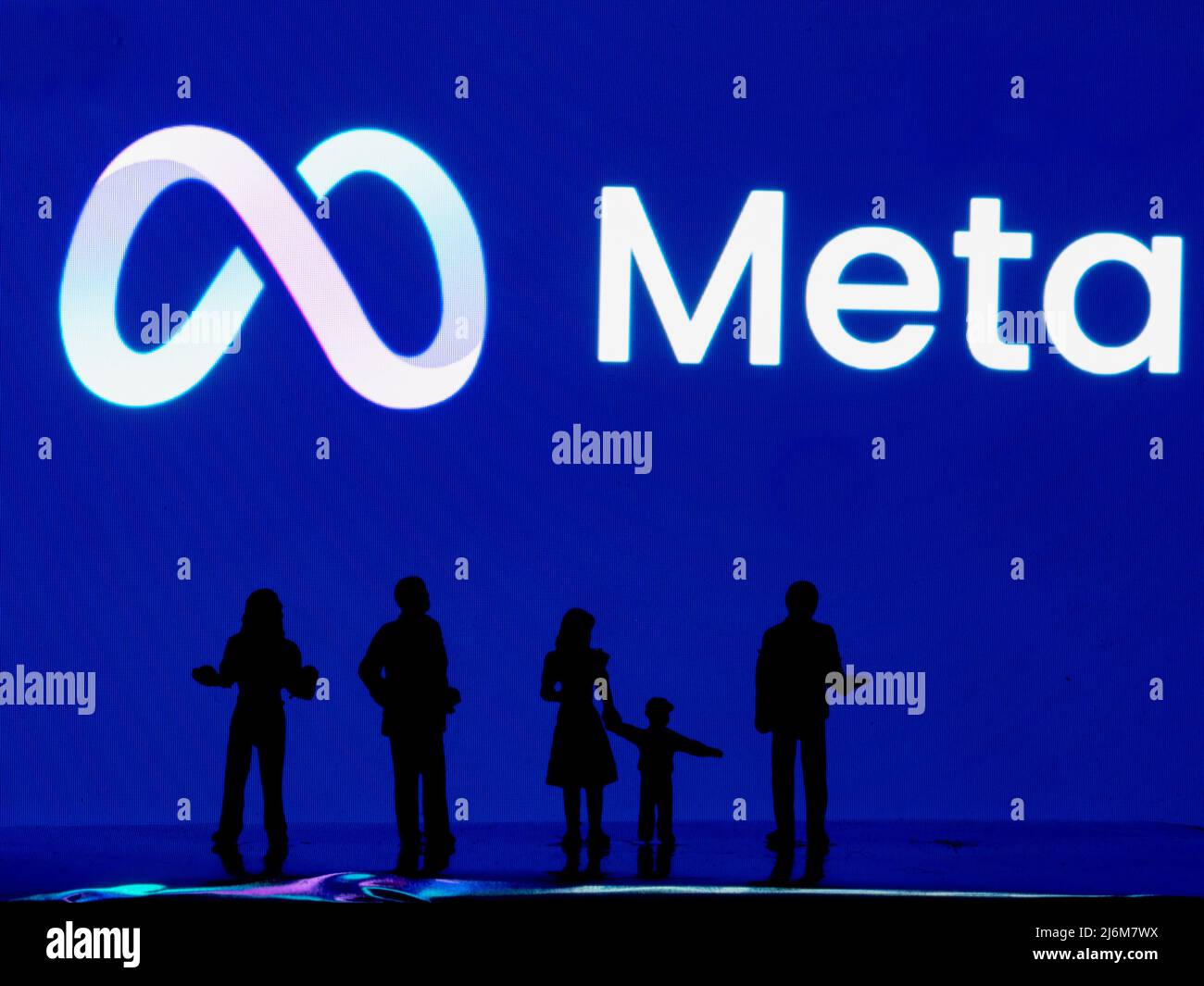 In this photo illustration, Miniature figures stand in front of a Meta Platforms Inc. logo on a ...